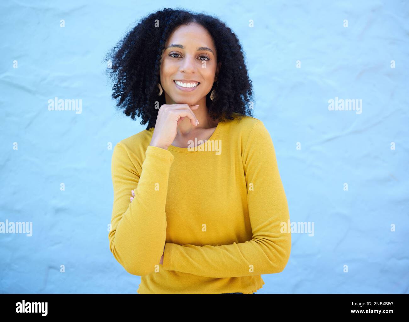 Portrait, proud and black woman in studio on mockup, space and blue background for advertising ...