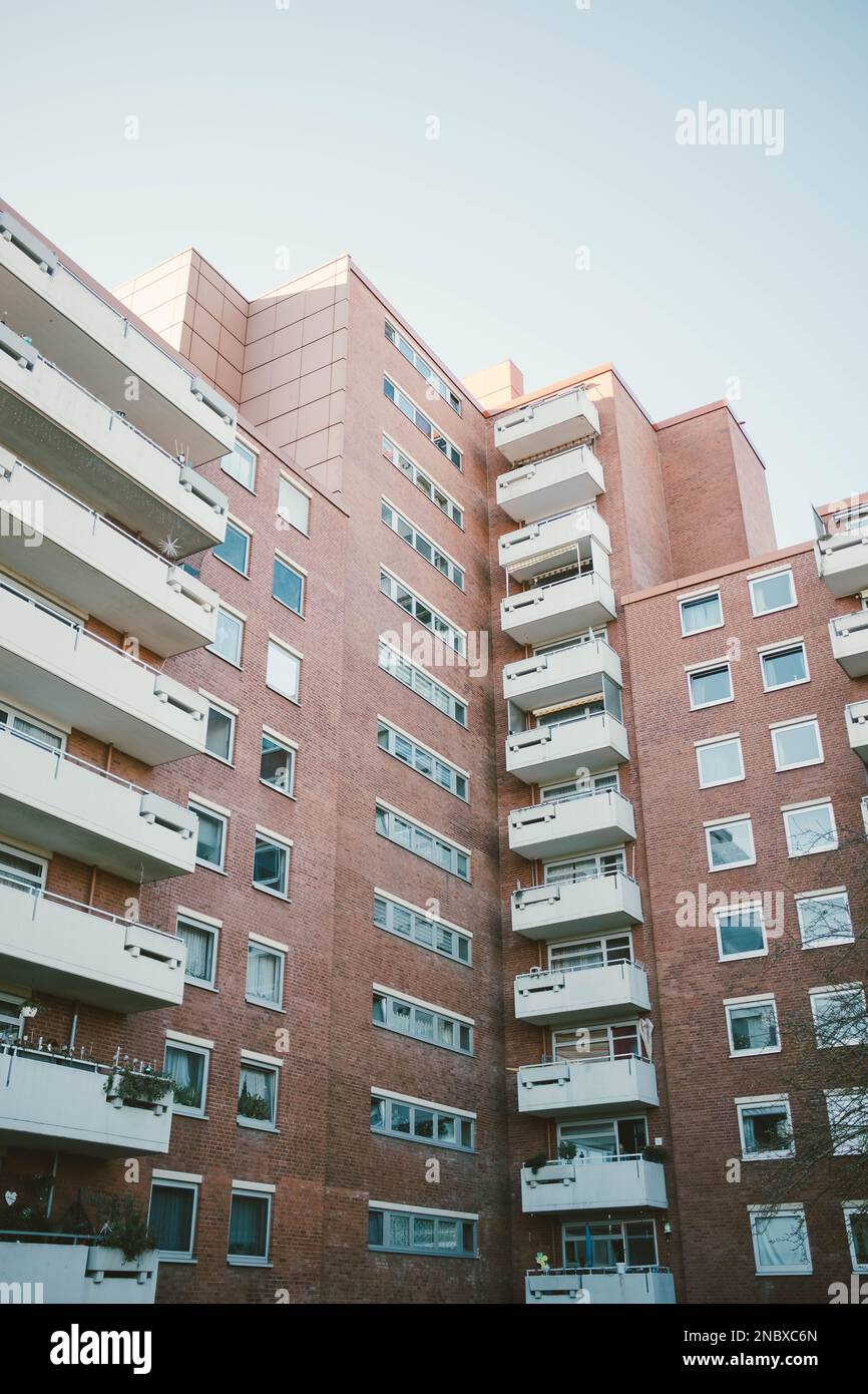A prefabricated house in the ghetto under a blue sky. The high-rise ...