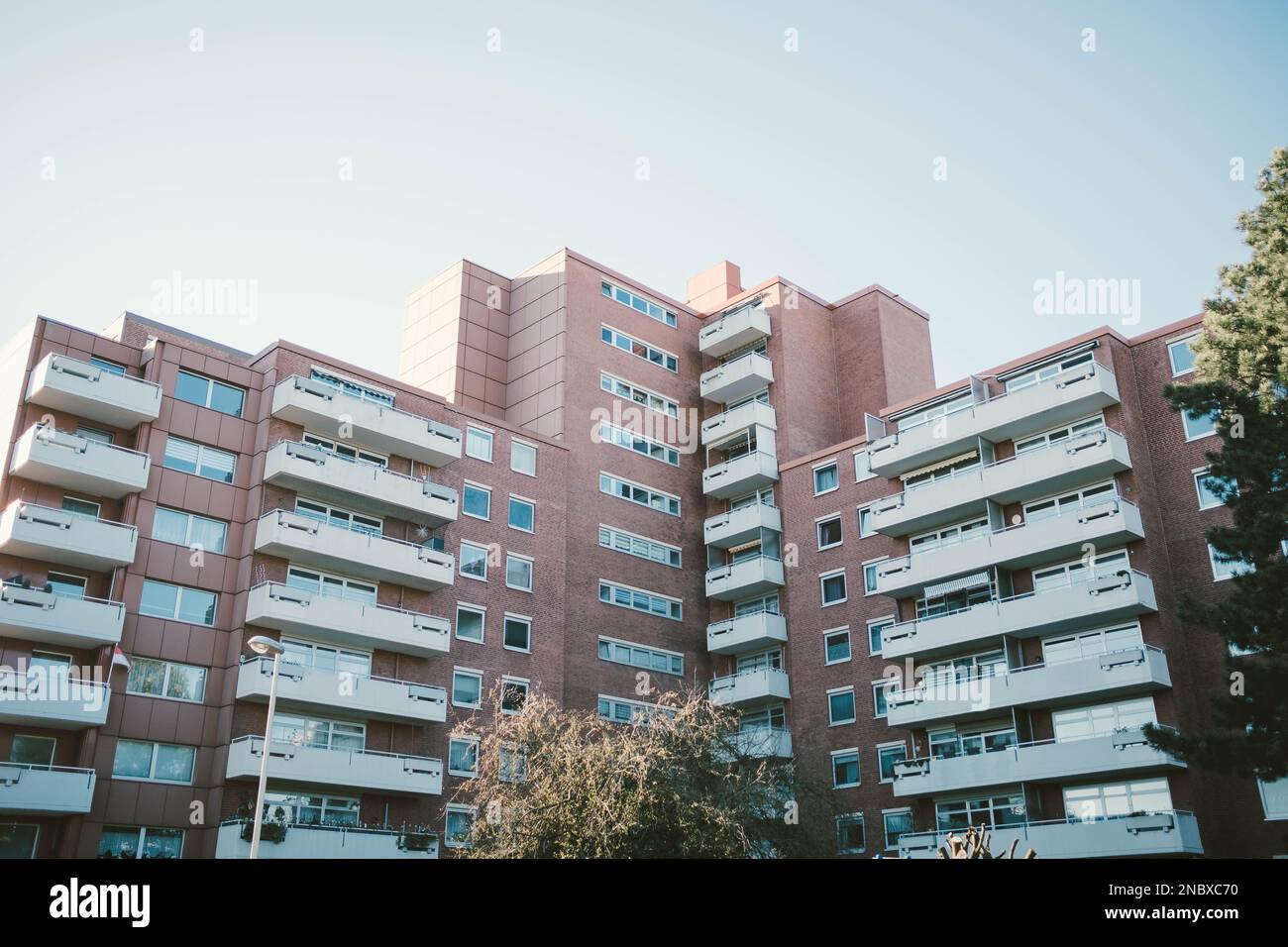 A prefabricated house in the ghetto under a blue sky. The high-rise ...