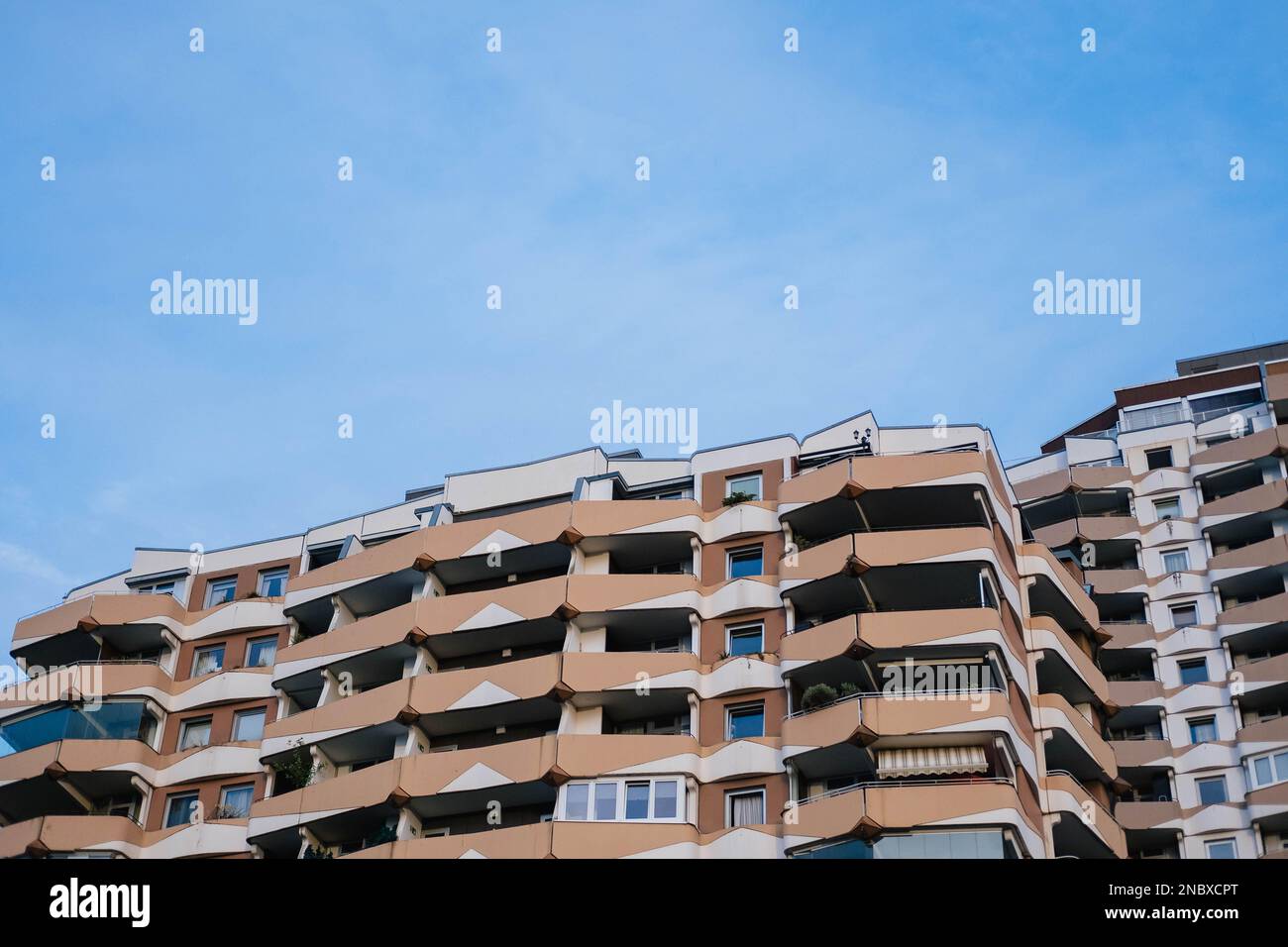 A prefabricated house in the ghetto under a blue sky. The high-rise ...