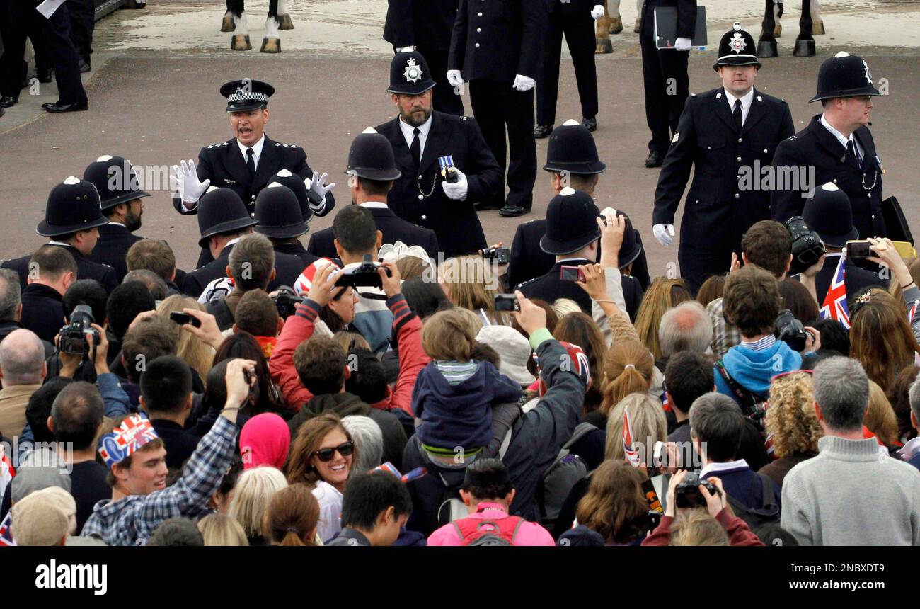 British police officers stop the crowd moving any further forward as ...