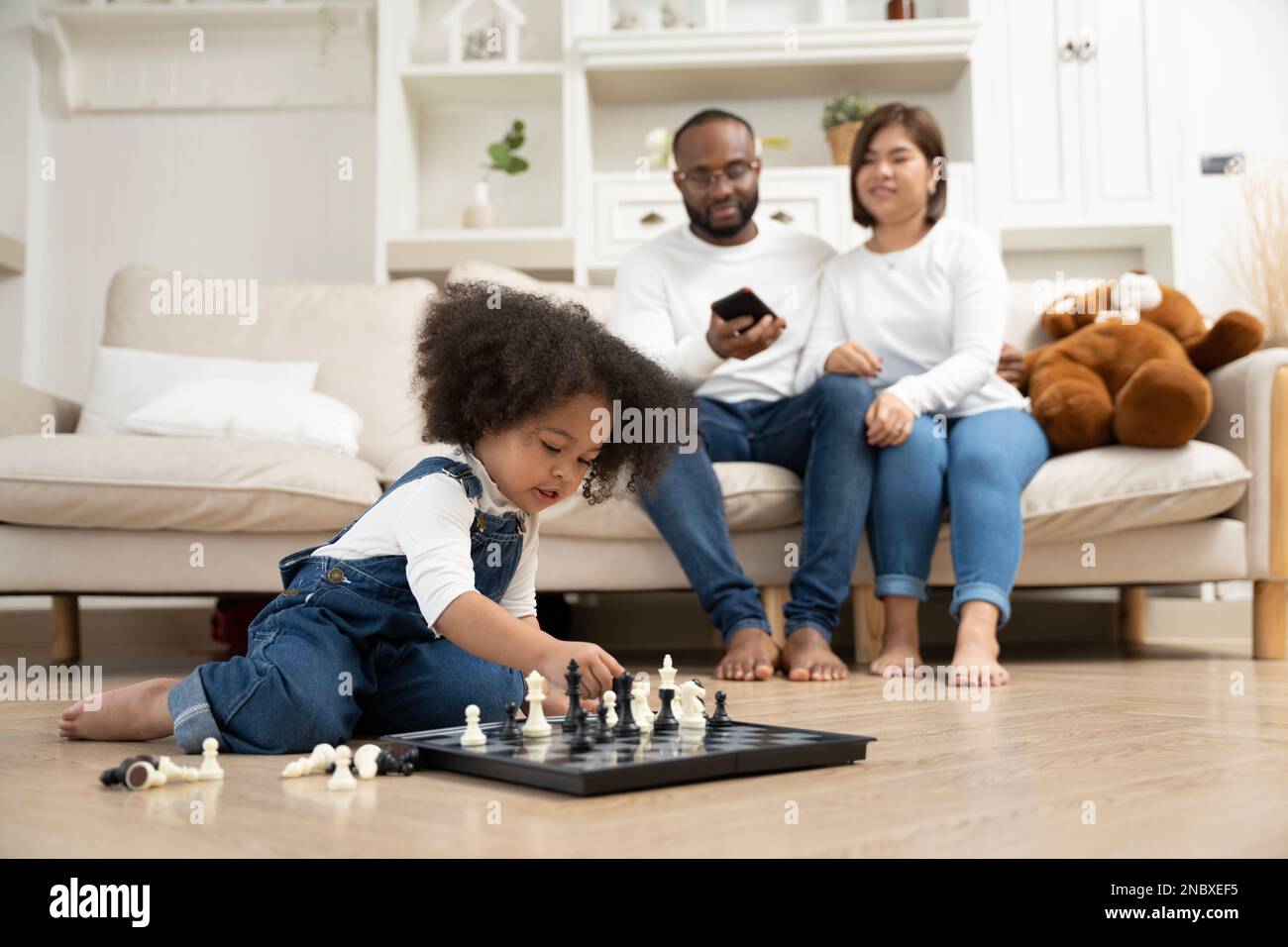 African family, father, mother, daughter doing various activities ...