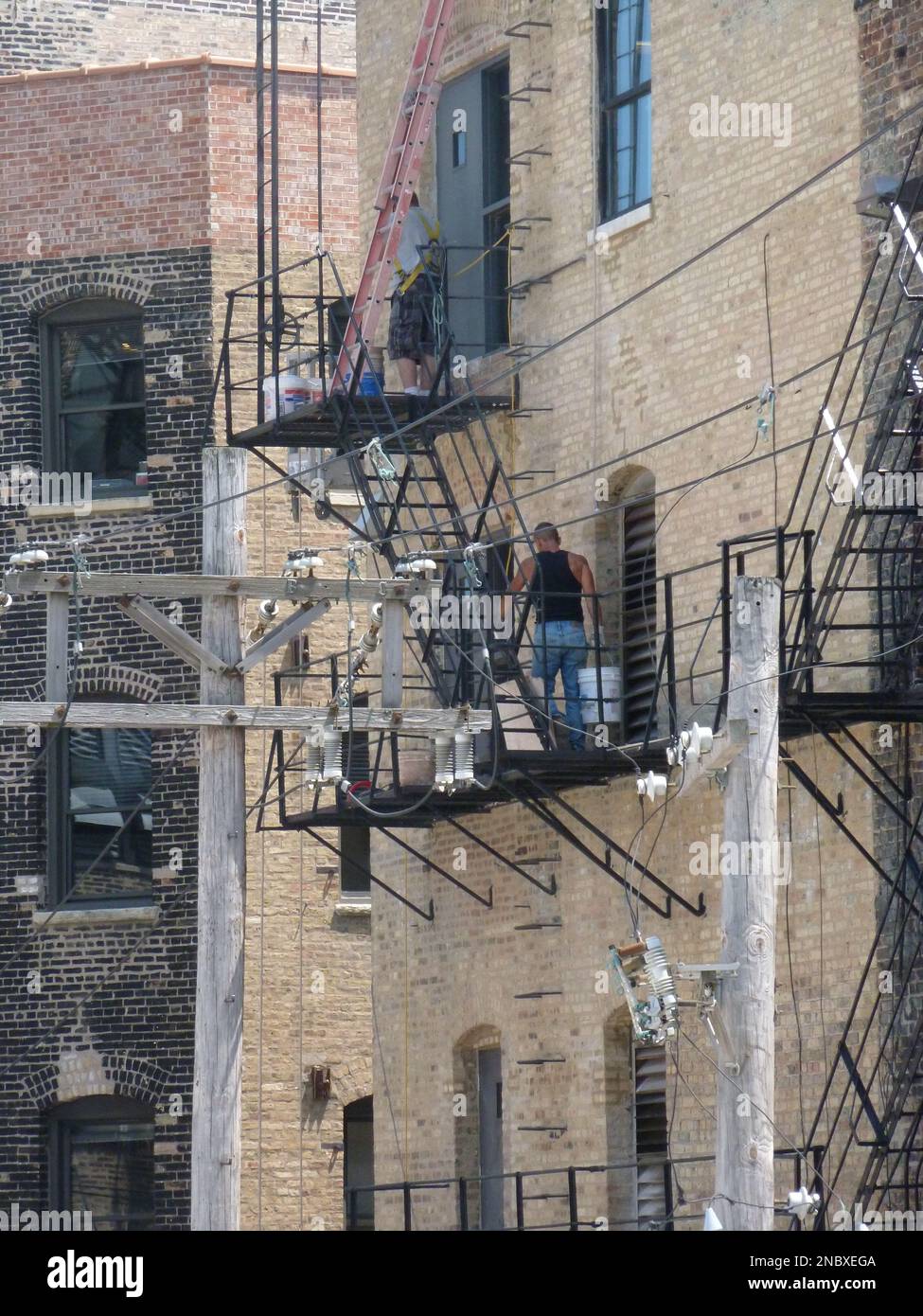 A vertical shot of people on the fire escape Stock Photo - Alamy