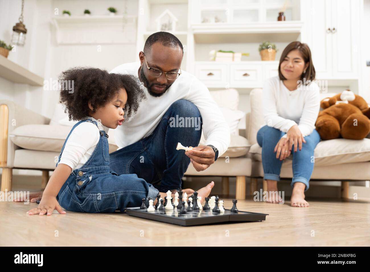 African family, father, mother, daughter doing various activities ...