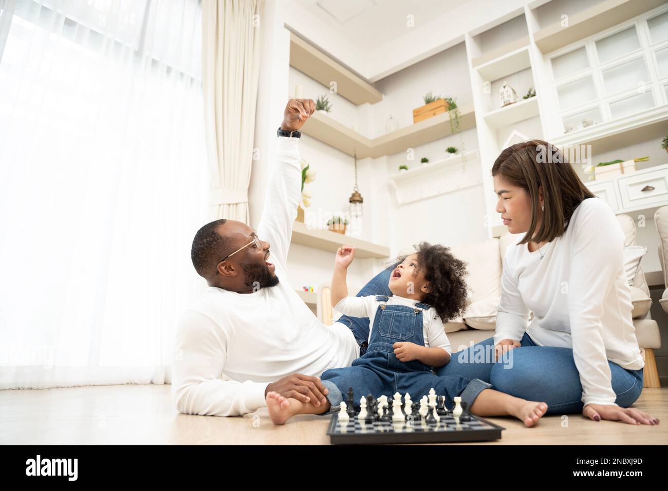 African family, father, mother, daughter doing various activities ...
