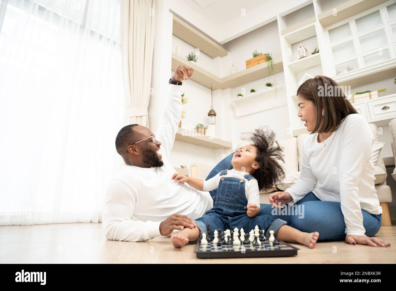 African family, father, mother, daughter doing various activities ...