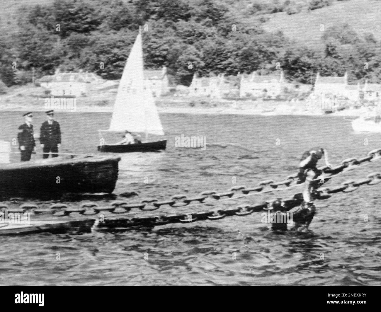 Navy frogmen in water, left, haul pacifist demonstrator from Anchor ...