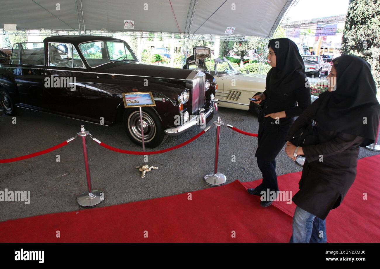 Two Iranian women look at a 1960 Rolls Royce Phantom of former Iranian ...