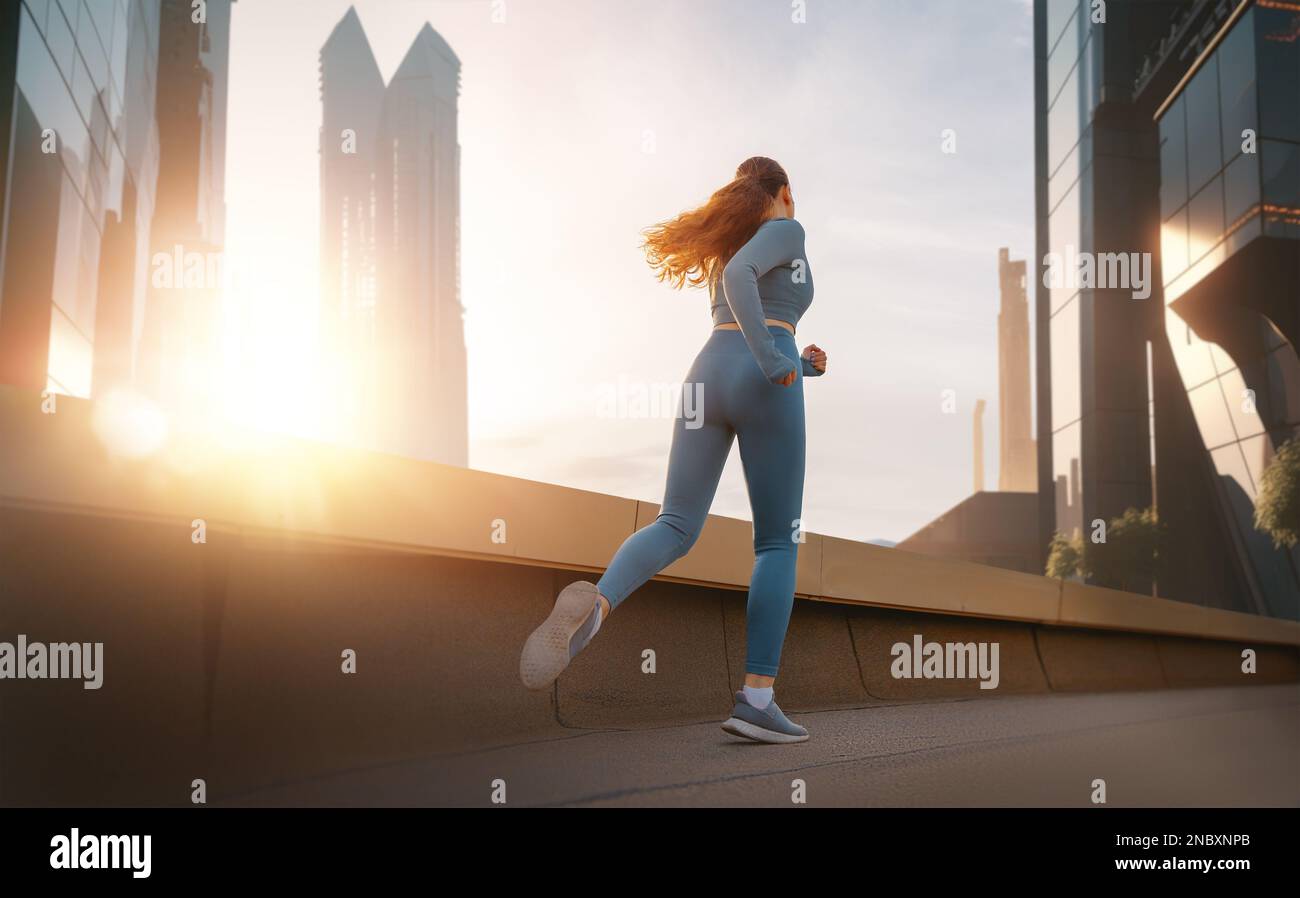 Athletic woman is running on rooftop of parking, garage on sunset ...