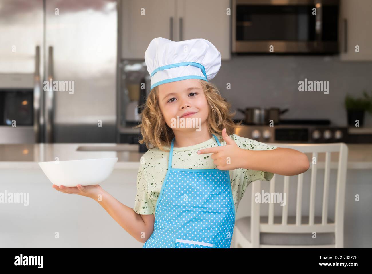 Fun kids kitchen. Funny little kid chef cook wearing uniform cook cap ...