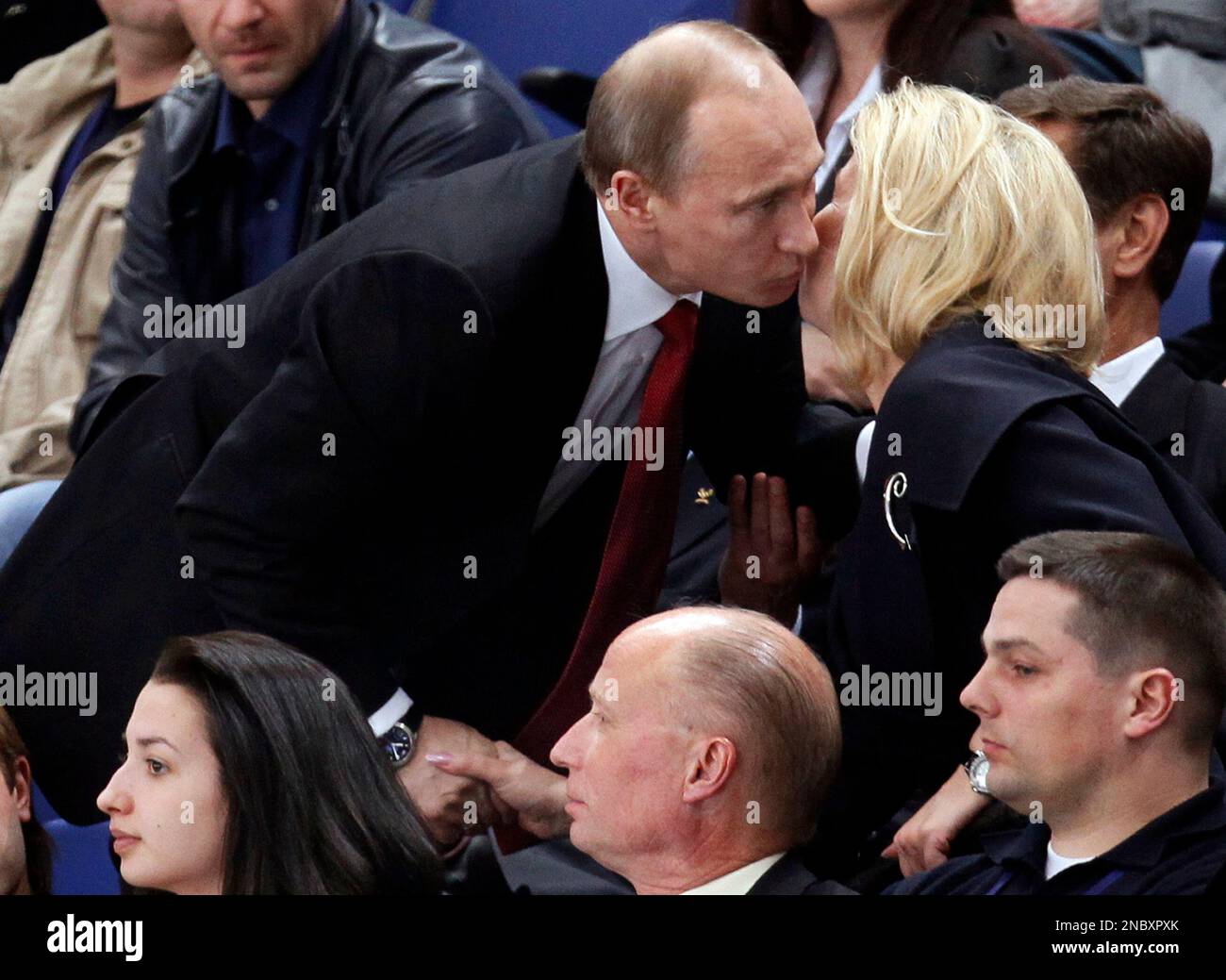 Russian Prime Minister Vladimir Putin, top left, kisses Russian ...