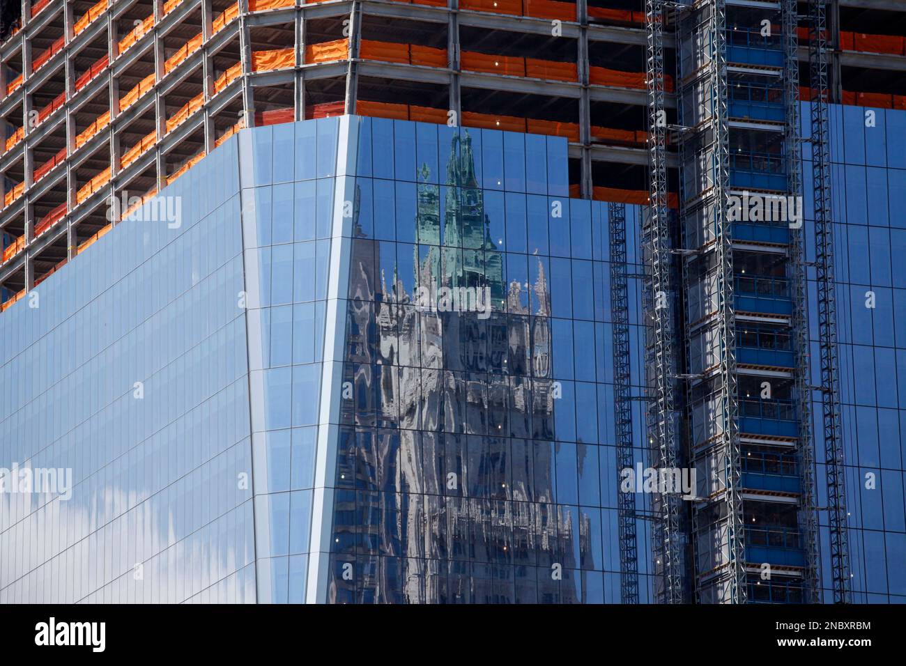 A neighboring building is reflected, center, in the glass window ...