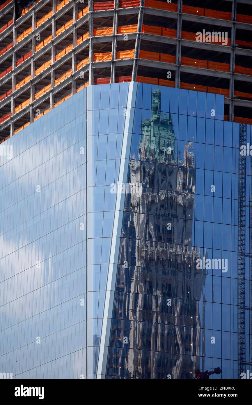 A neighboring building is reflected in the glass window curtain wall of ...