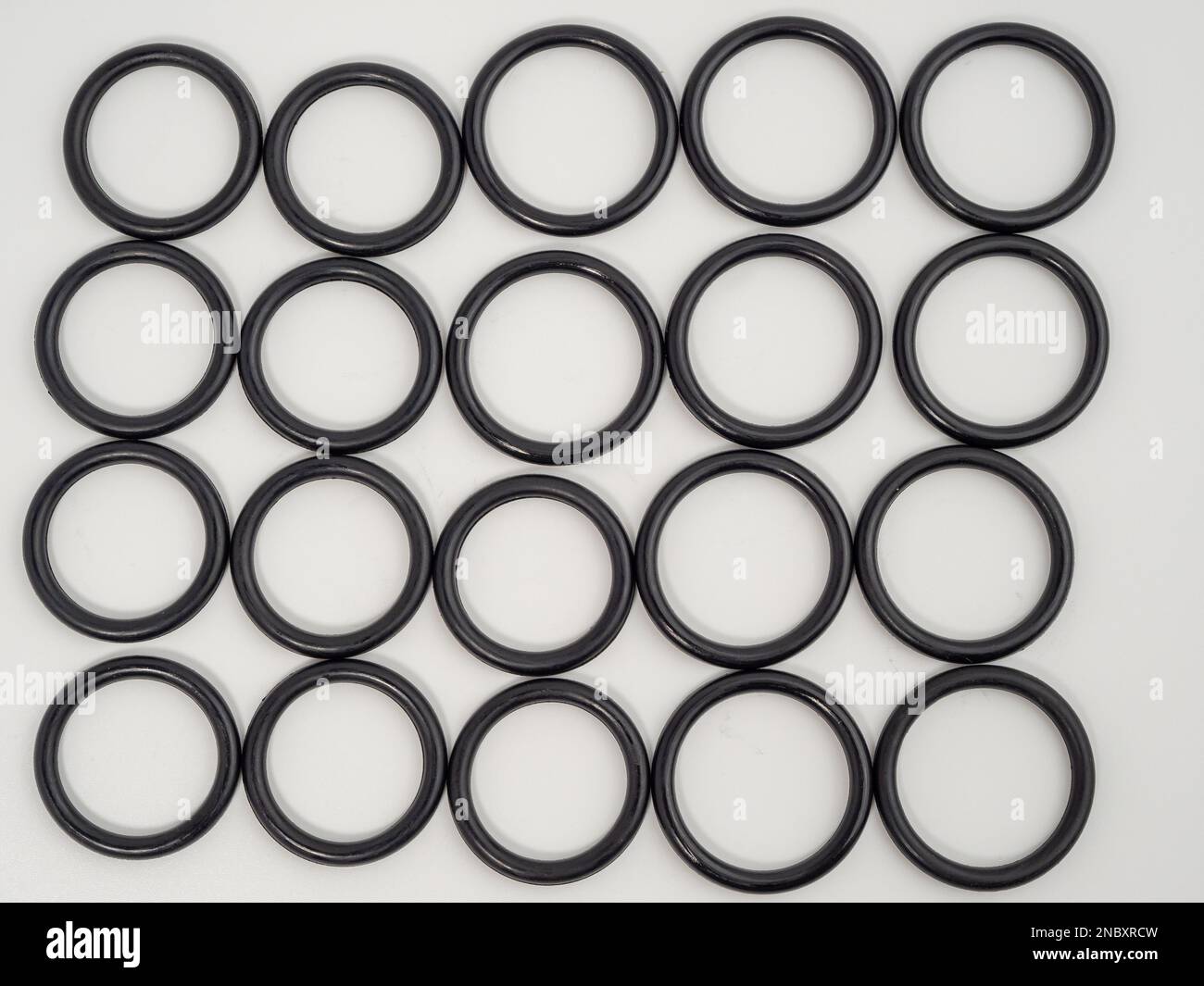 Hydraulic and pneumatic o-rings in black in different sizes on a white ...