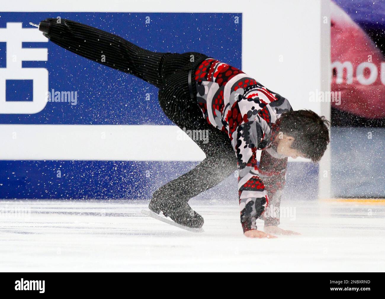 Japan's Takahiko Kozuka makes a mistake on landing after a jump as he ...