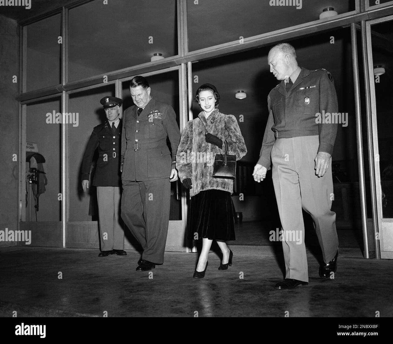 Princess Margaret walks between Air Chief Marshal Sir Hugh Saunders ...