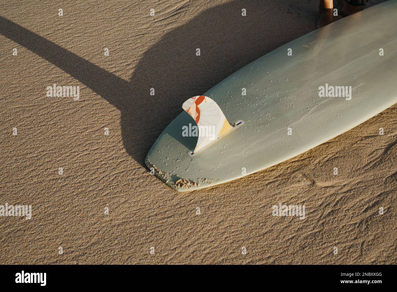 Close up of underside of surfboard lying on the beach Stock Photo - Alamy