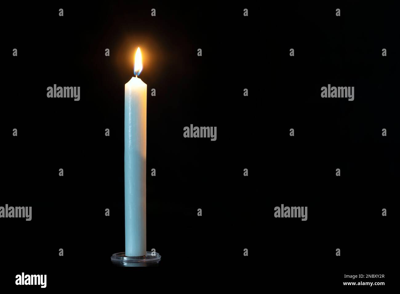 Close up single candle light and flame on black background copy space ...