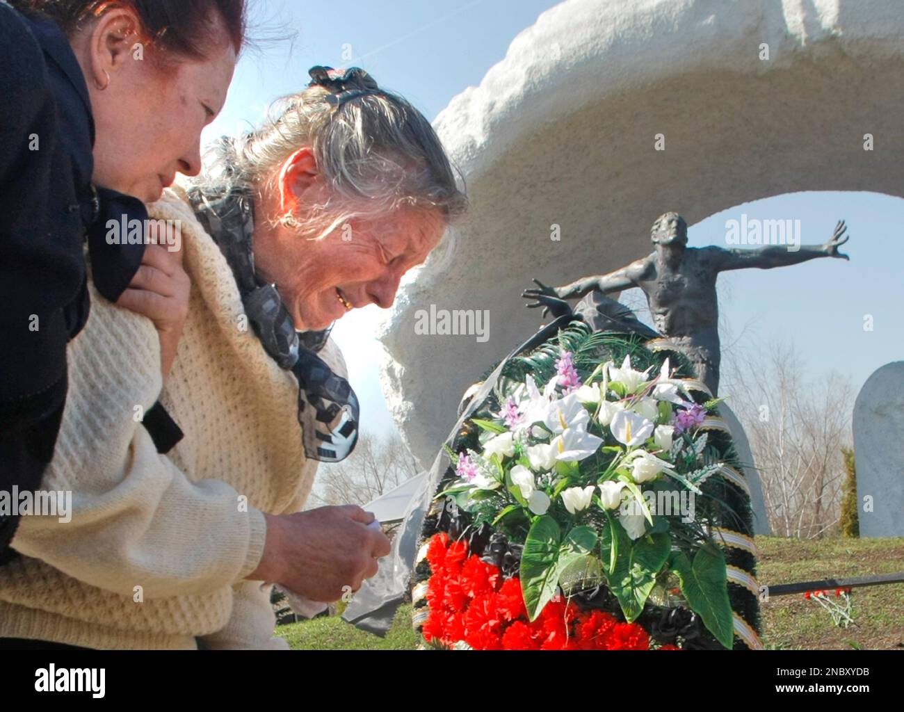 An unidentified relative, left, consoles Vera Toptunova, the mother of ...
