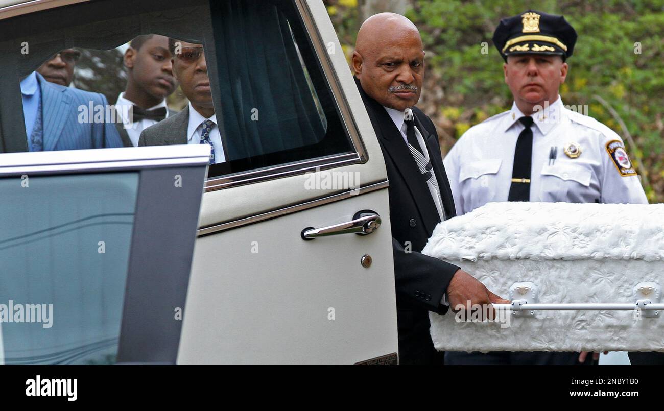 The casket of one of three children is placed in a hearse in Spring ...