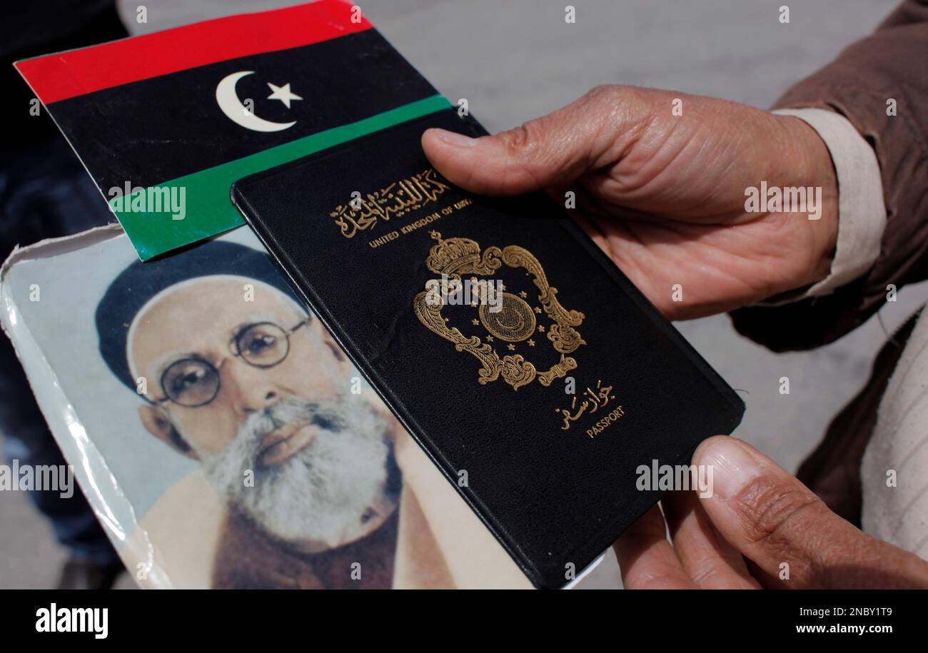 A Libyan man displays Items of the pre Gadhafi era, a passport of his ...