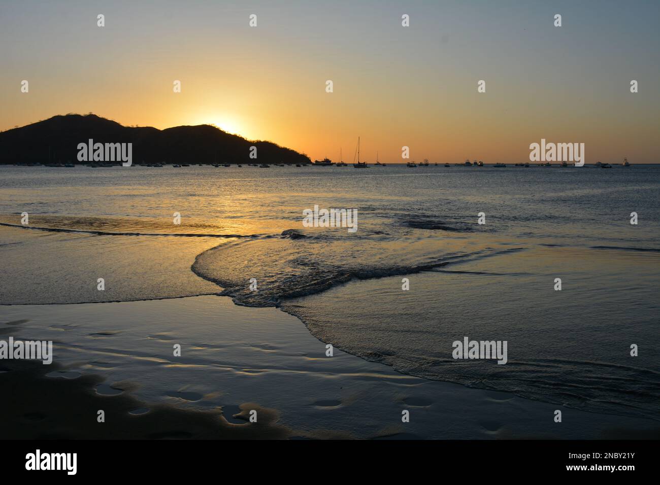 Wave patterns on water covered beach on Playa Coco, Costa Rica, at ...
