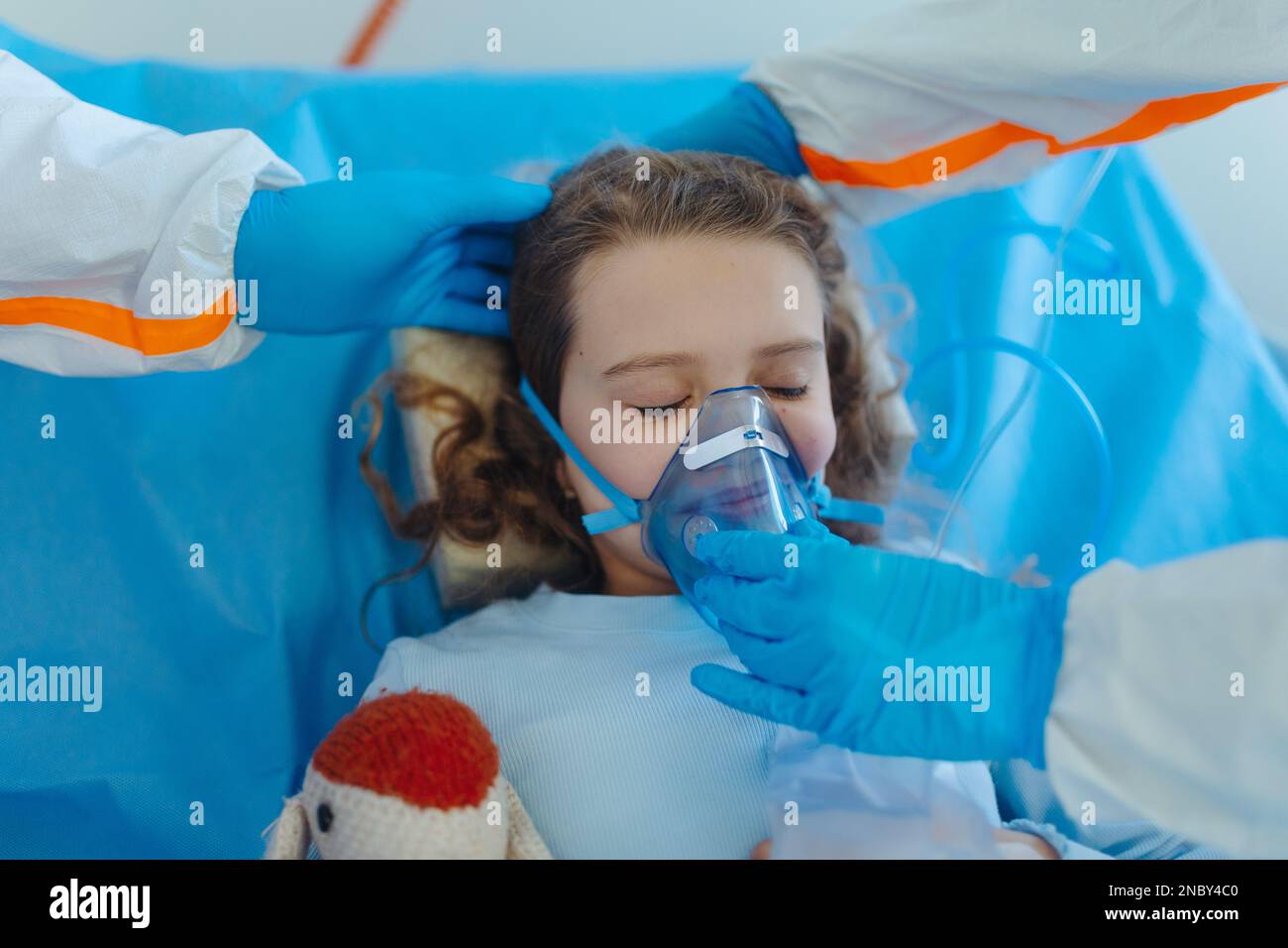 Close-up of little girl with infection disease lying in hospital room ...