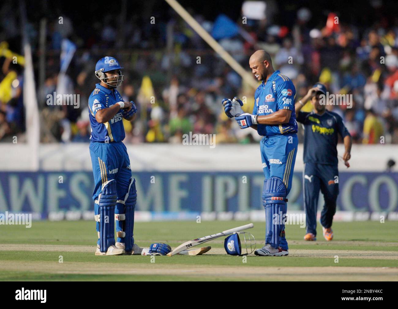Mumbai Indians batsmen Rohit Sharma, left, and Andrew Symonds adjust ...