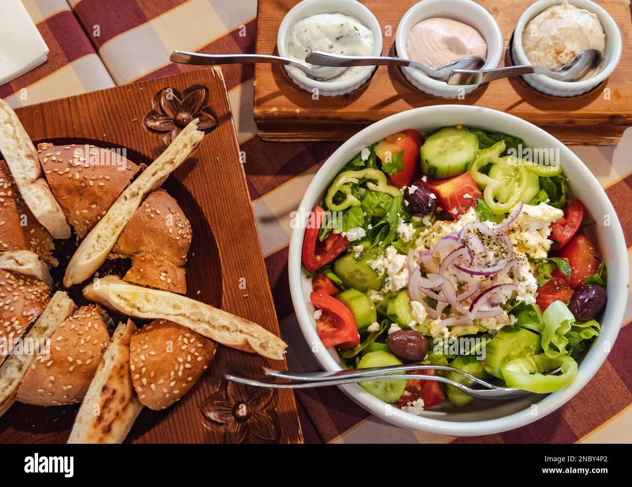 Greek Village Salad, bread and dips in restaurant in Cyprus island ...