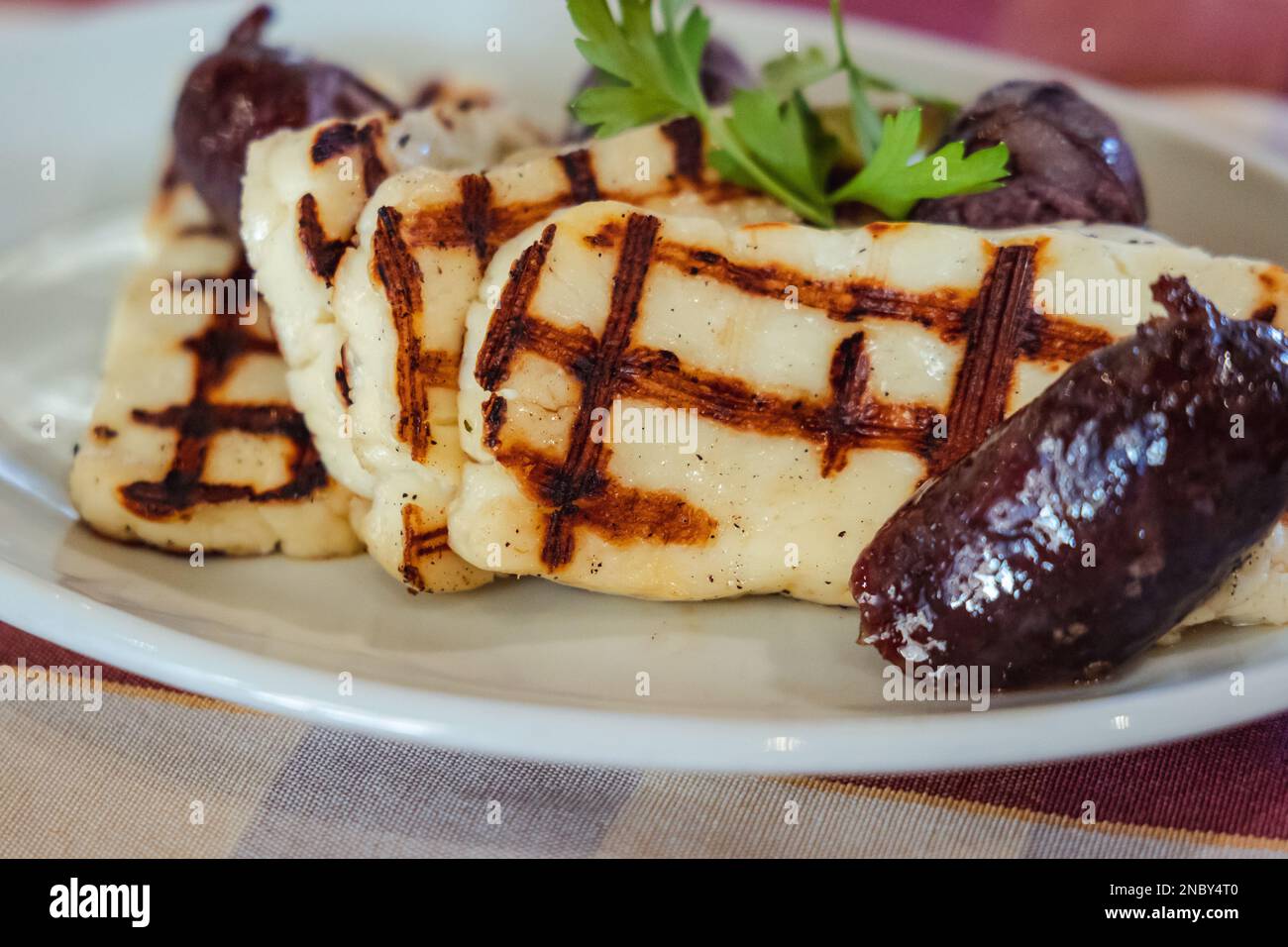 Grilled Halloumi - traditional Cypriot cheese and sausages on a plate ...