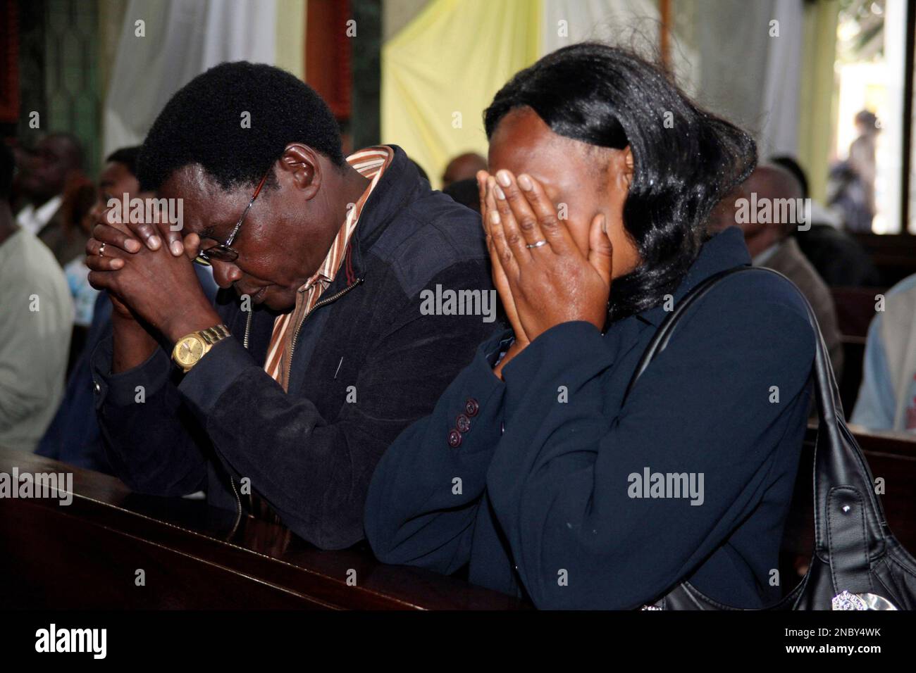 Kenyan Christians pray as they join a morning service at Holy Family ...