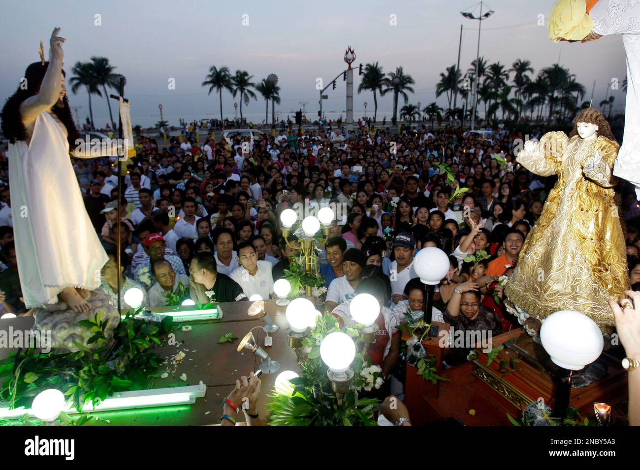 Devotees look as the images of the Blessed Virgin Mary, right, and ...