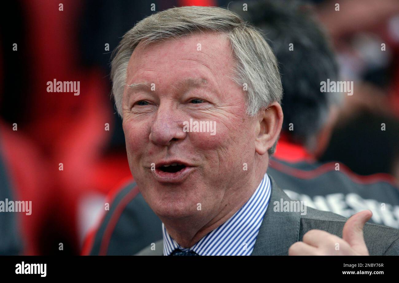 Manchester United's manager Sir Alex Ferguson smiles as he returns to ...