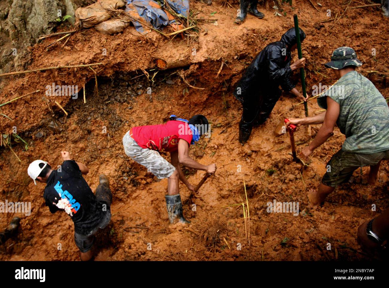 Rescuers search for victims of landslide at a mining camp of Pantukan, Compostela Valley on ...