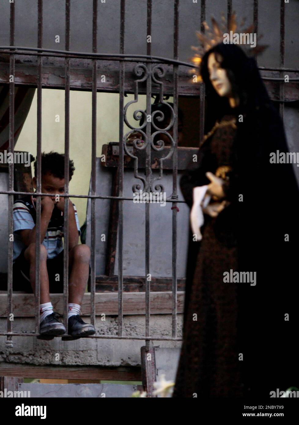 A boy watches a Holy Week procession on Good Friday in Havana, Friday ...