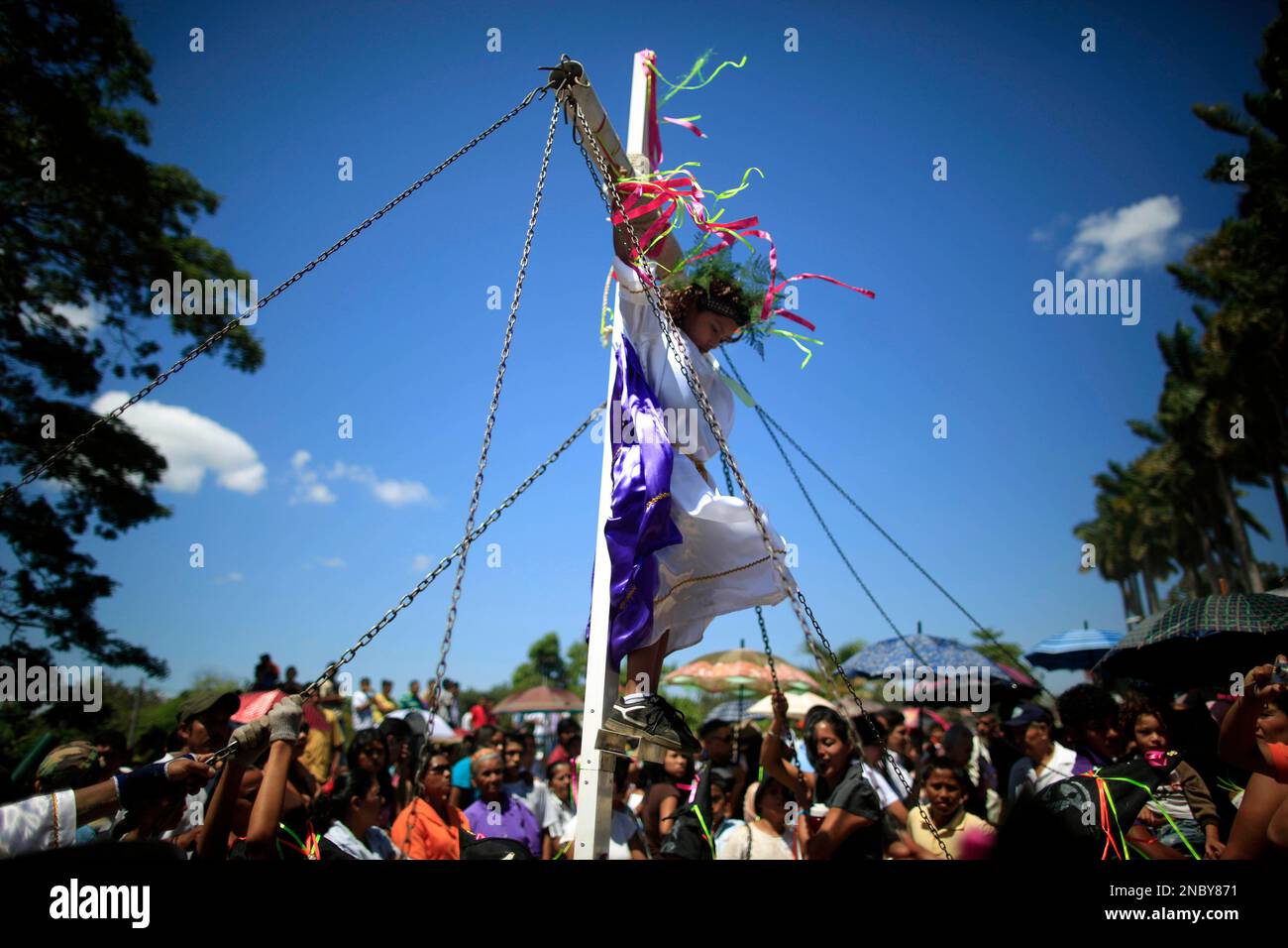 A child playing Jesus Christ is seen in a cross as he takes part in ...