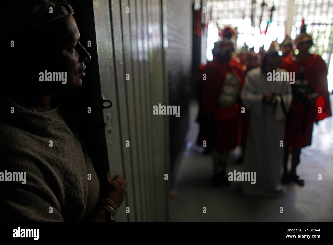 An inmate watches as other inmates dressed as Roman soldiers lead ...
