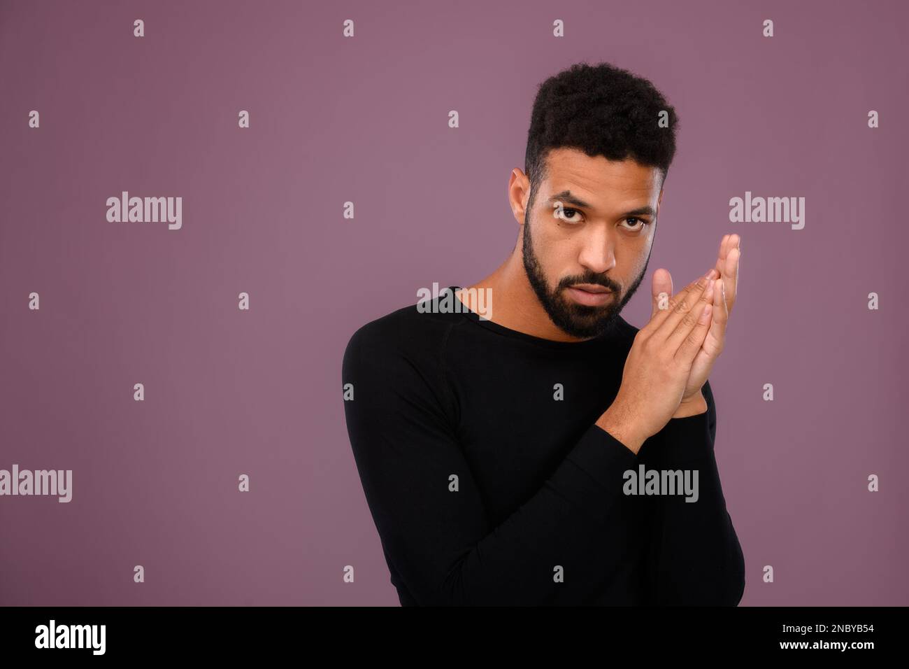 Portrait of young multiracial man in studio Stock Photo - Alamy