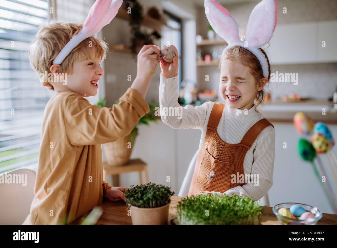 Little kids with bunny ears celebrating easter, playing easter game ...