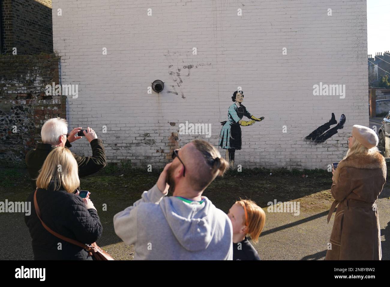 Members of the public look at the new artwork by street artist Banksy ...