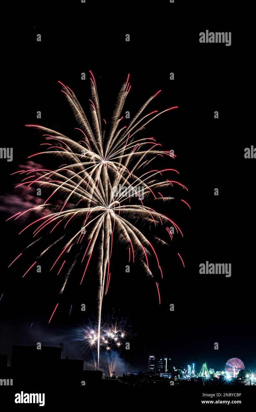 Vertical image of a fireworks show with pyrotechnics launched at ...