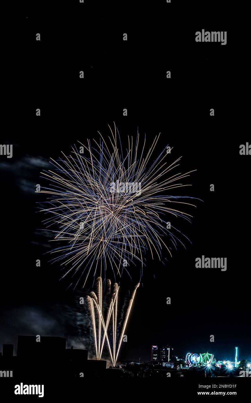 Vertical image of a fireworks show with pyrotechnics launched at ...