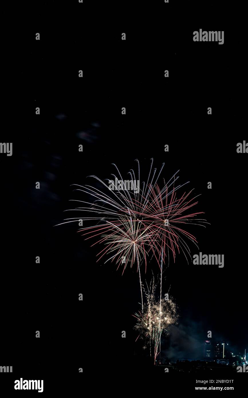 Vertical image of a fireworks show with pyrotechnics launched at ...