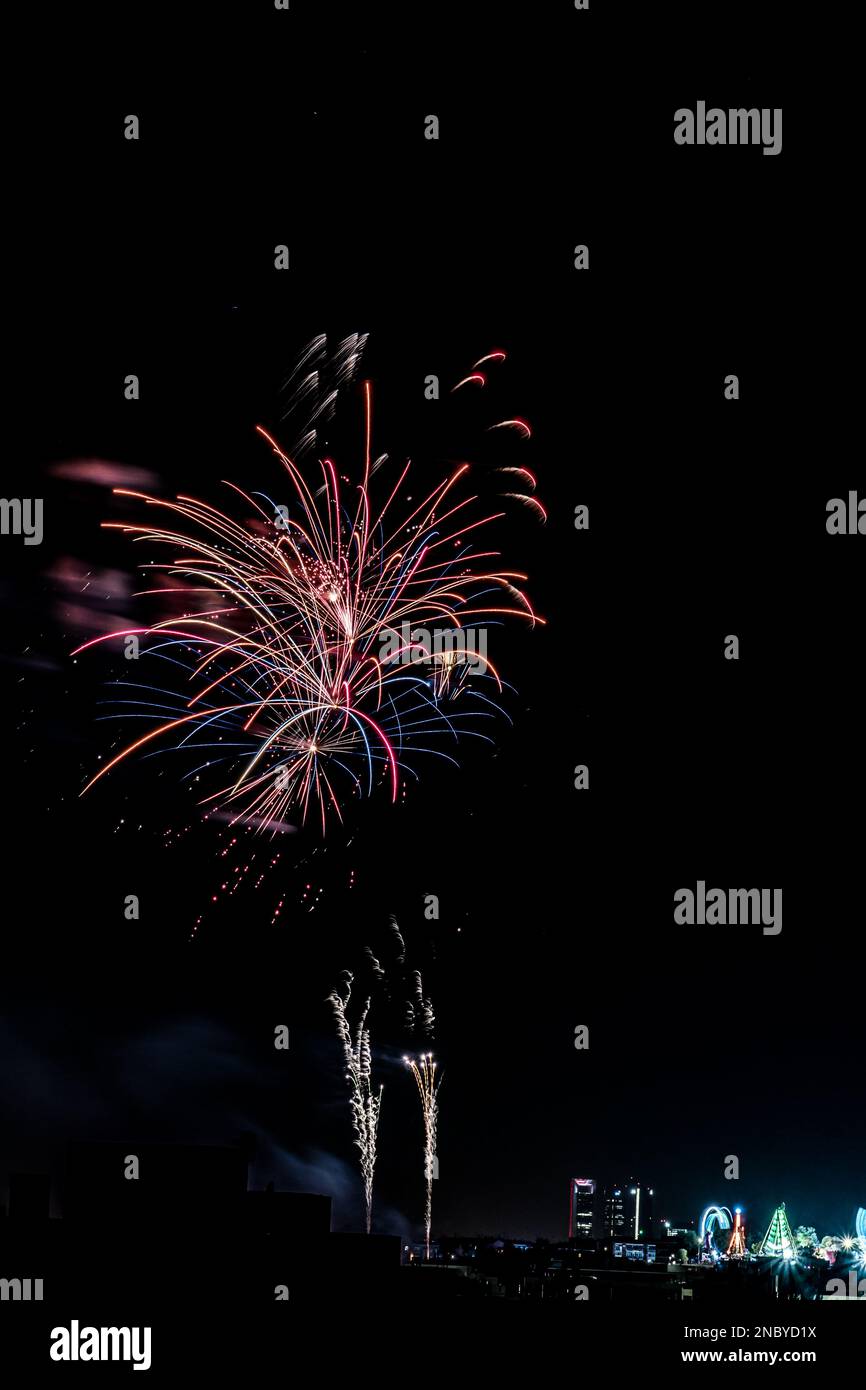 Vertical image of a fireworks show with pyrotechnics launched at ...
