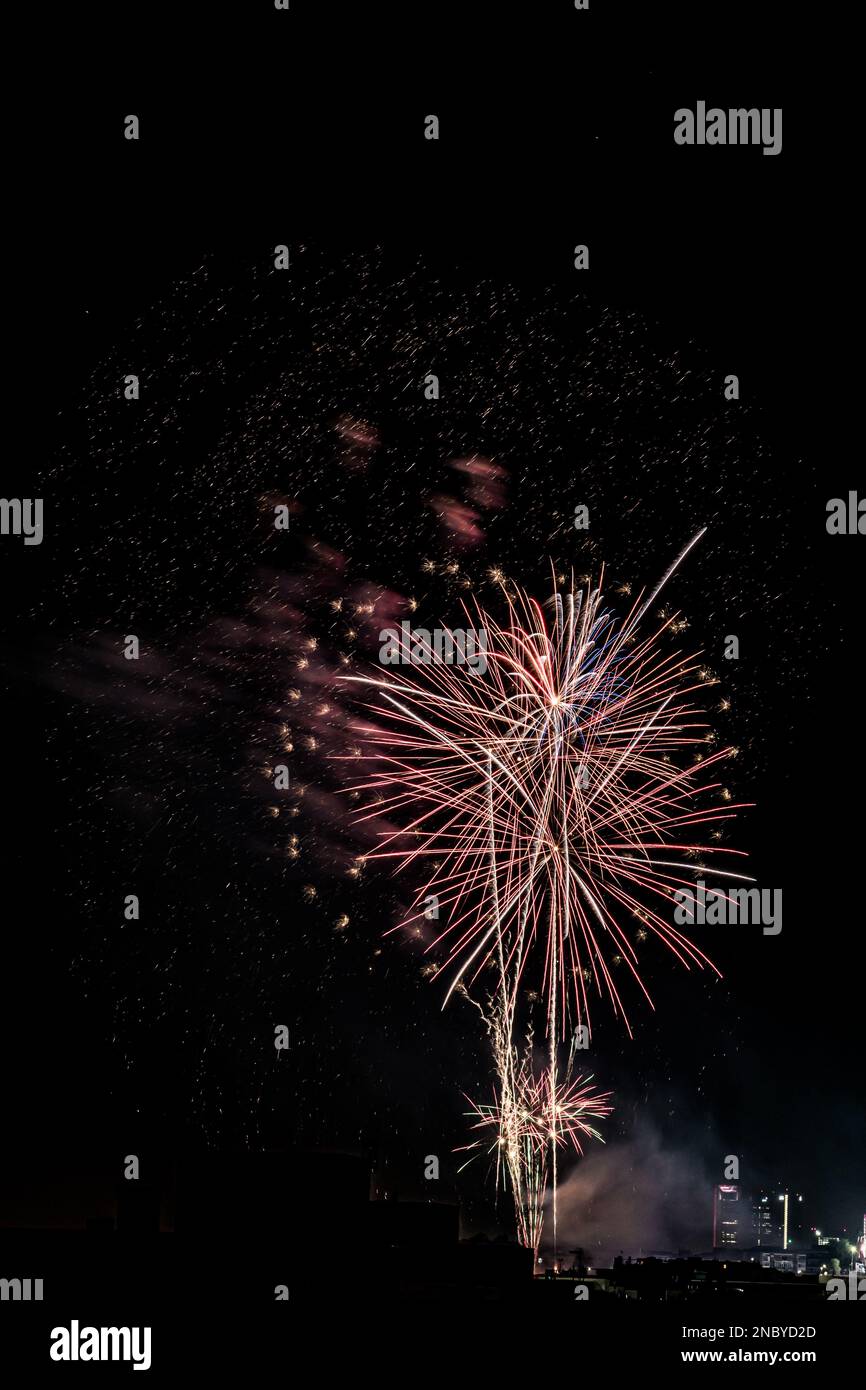 Vertical image of a fireworks show with pyrotechnics launched at ...