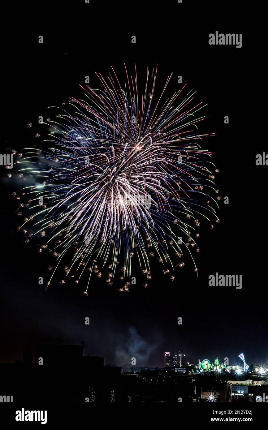 Vertical image of a fireworks show with pyrotechnics launched at ...