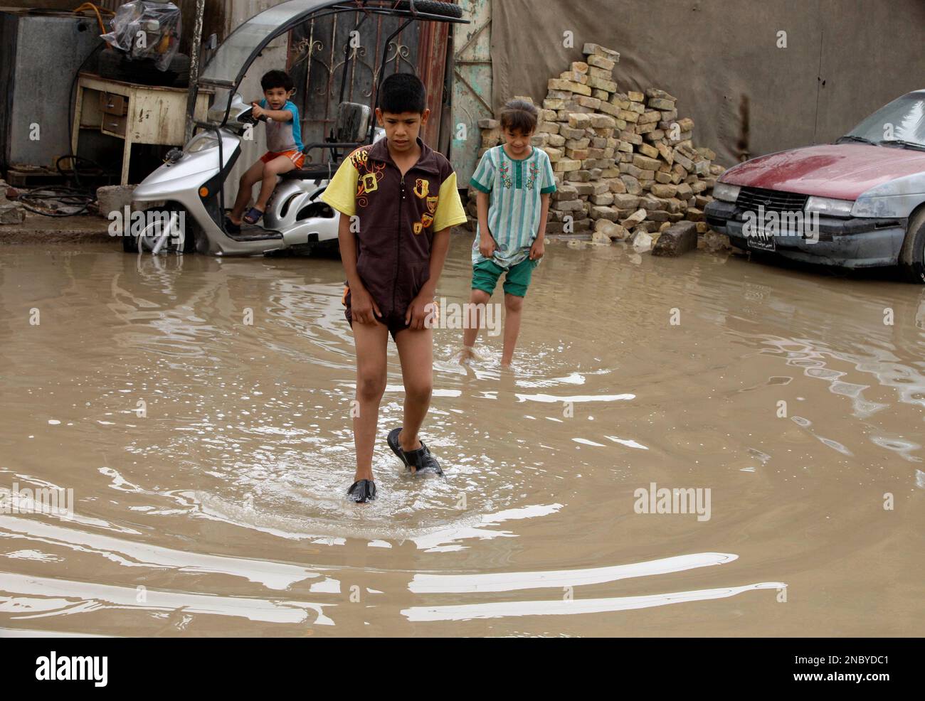 Children cross a street in the Sadr City neighbourhood of Baghdad, Iraq ...