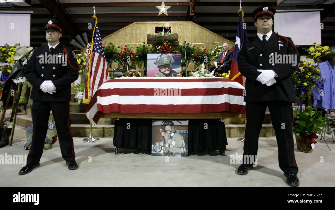 Firefighter honor guards stand watch over the casket of firefighter ...