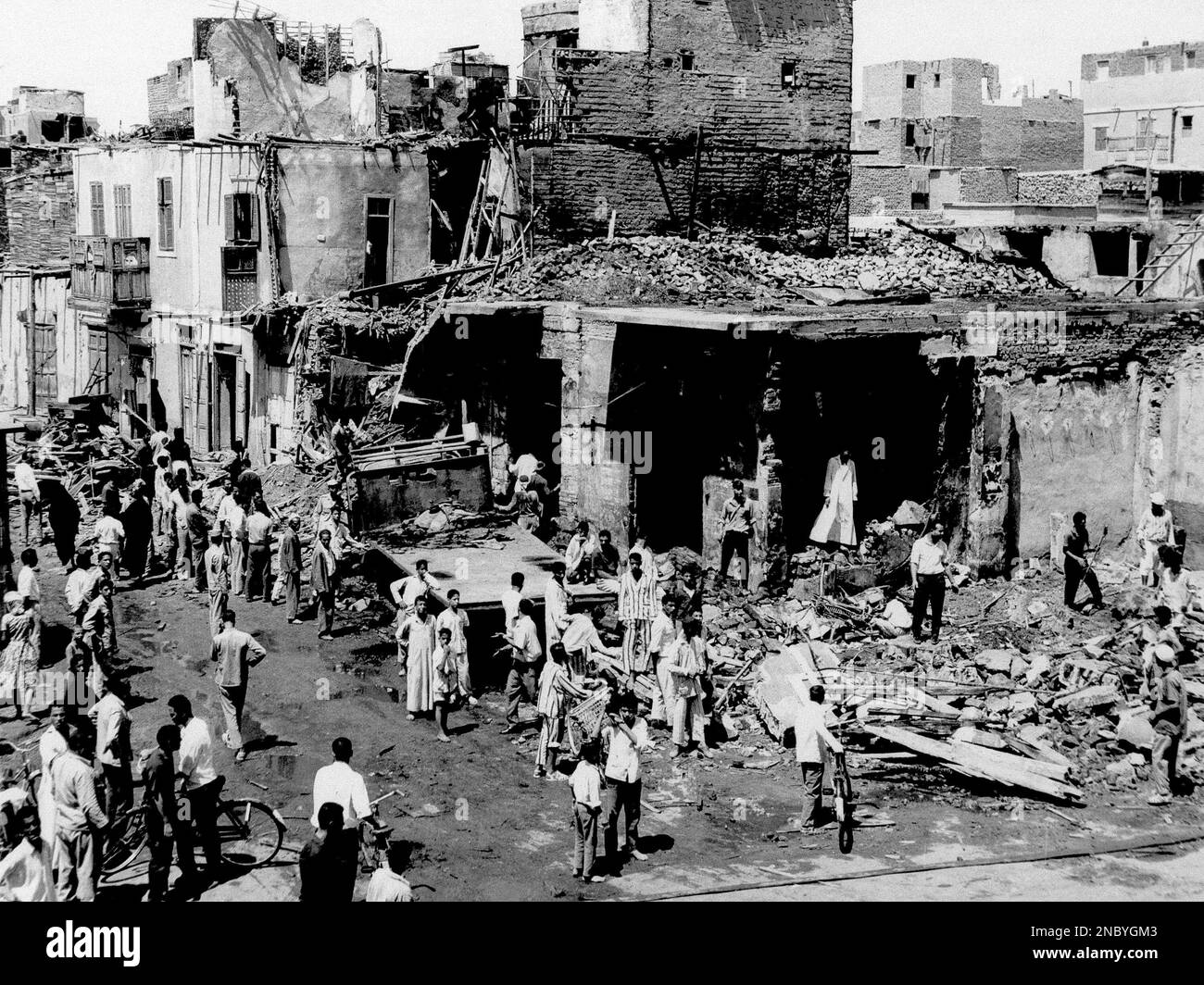 Civilians stand amid debris on July 9, 1968 of Suez Homes damaged on ...