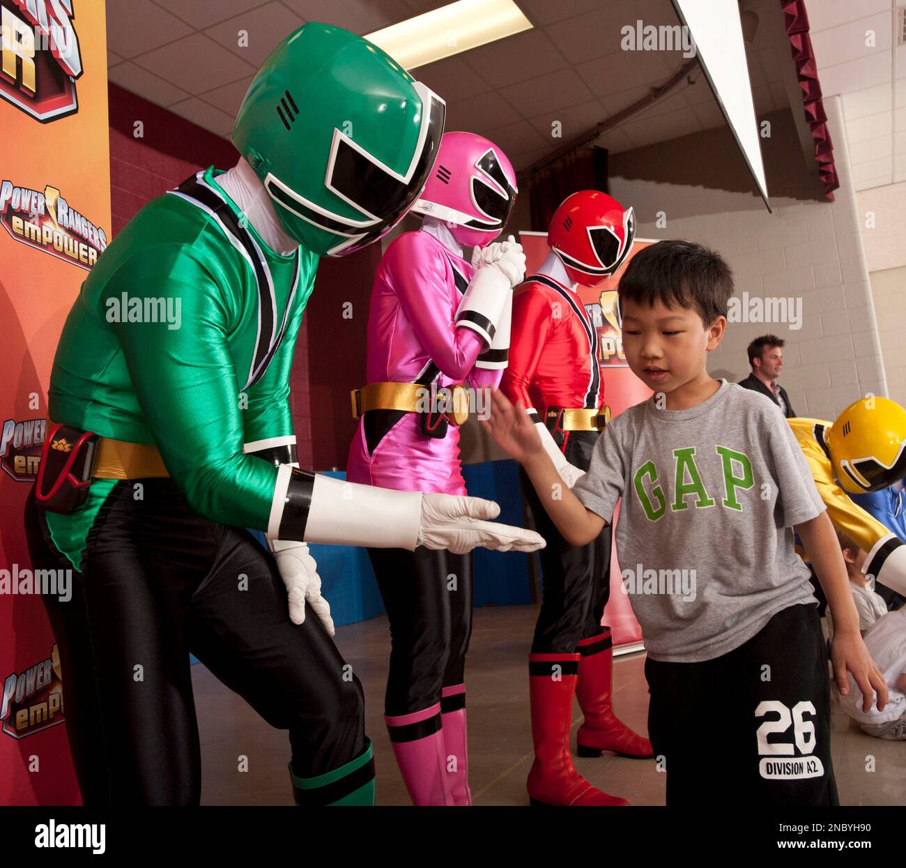 A Reagan Elementary School student gives the green power ranger a high ...